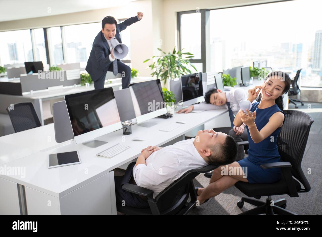 Angry manager yelling at employees through megaphone in office Stock ...