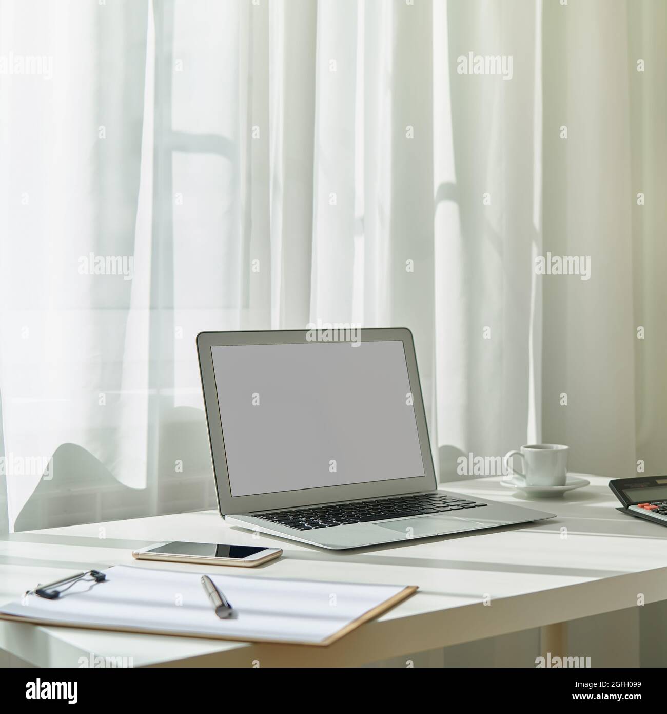 Freelance table, home office. Computer empty screen, cellphone, coffee ...