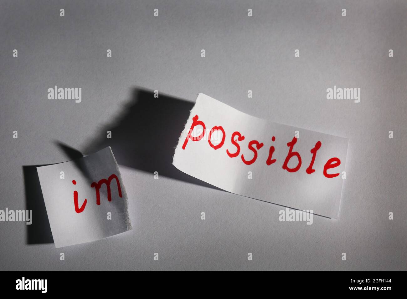 Cut out word IMPOSSIBLE on white background Stock Photo - Alamy