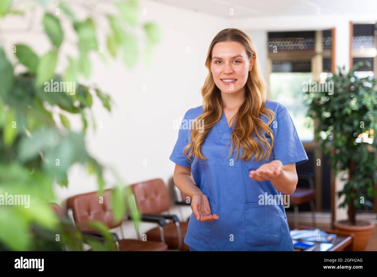 Positive female doctor posing in private clinic Stock Photo - Alamy
