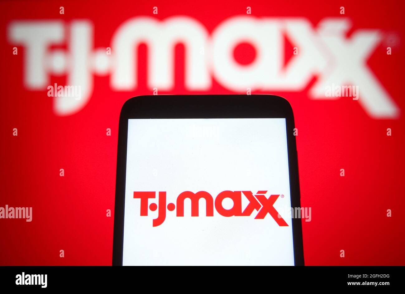 In this photo illustration a TJ Maxx logo is seen on a smartphone and a ...