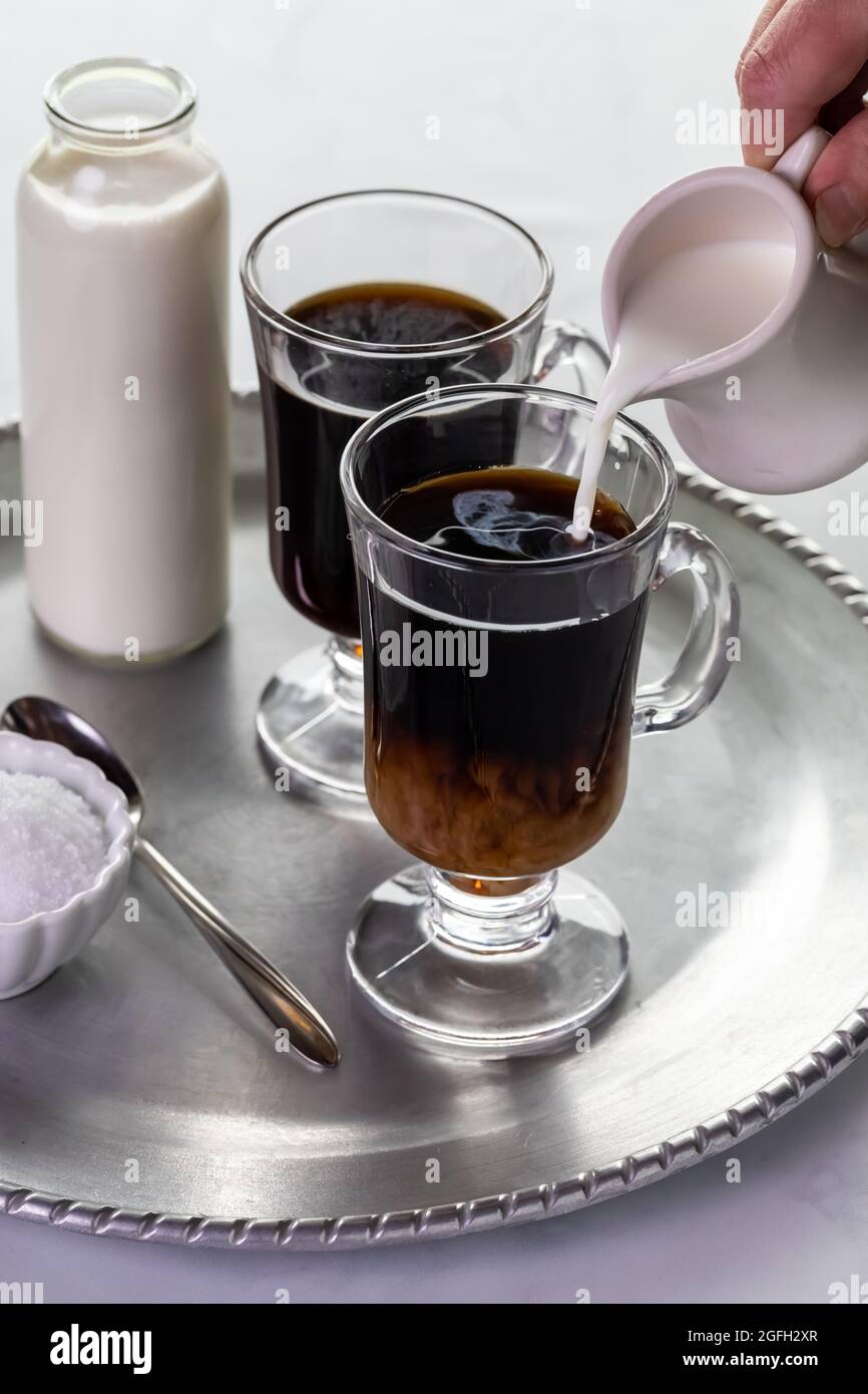 Pouring Cream Into Coffee