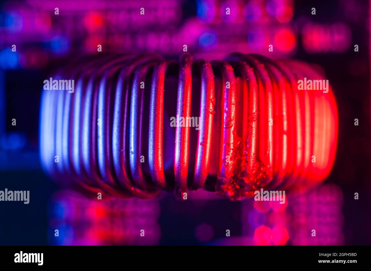 Single copper induction coil with copper wire on electronic PCB close ...