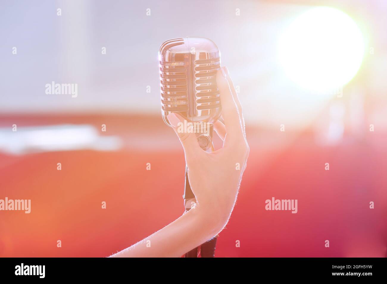 Female hand holding retro microphone, close up Stock Photo - Alamy