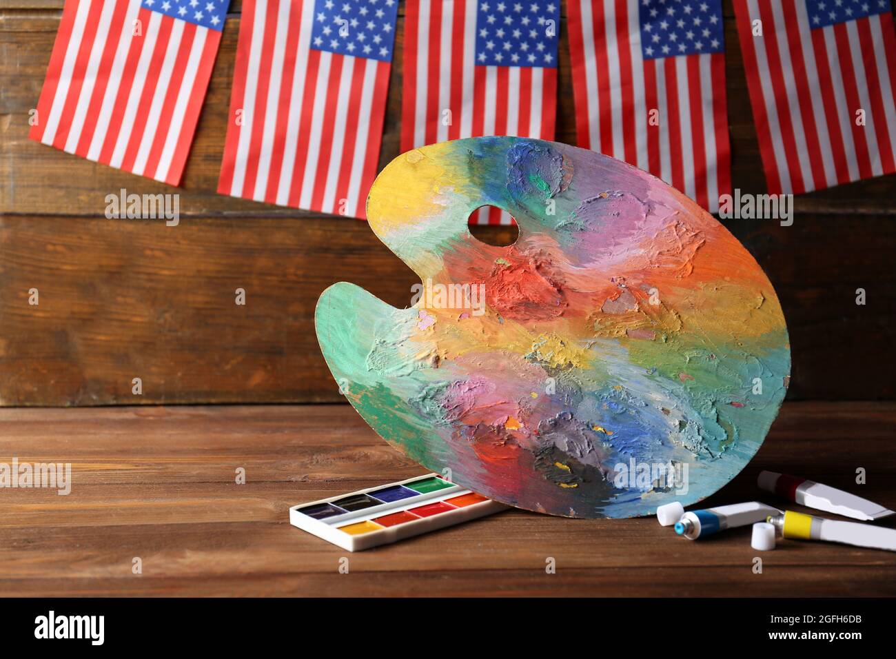 American flags with paint and palette on wooden background Stock Photo ...