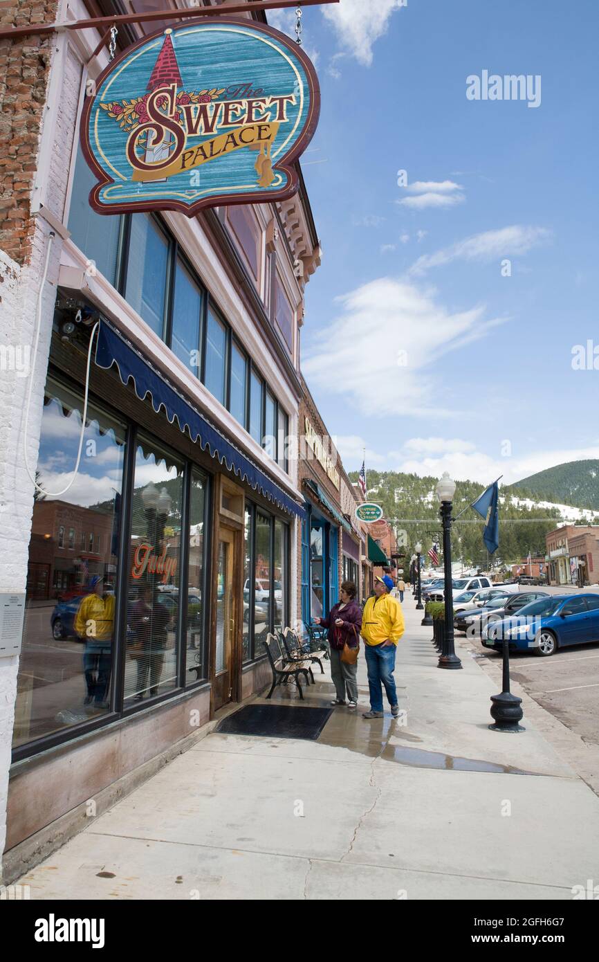 Visitors walk on the sidewalk in front of the brightly decorated Sweet ...