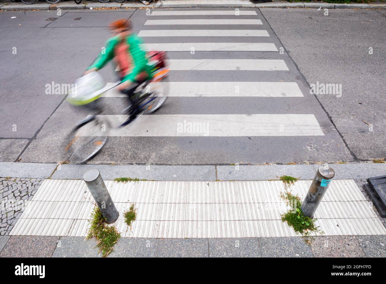 Berlin, Germany. 25th Aug, 2021. A cyclist crosses a zebra crossing at ...