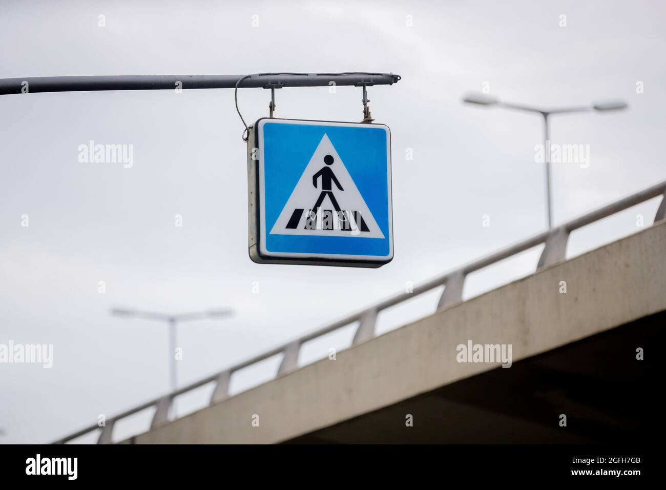 Berlin, Germany. 25th Aug, 2021. A sign for a pedestrian crossing hangs ...