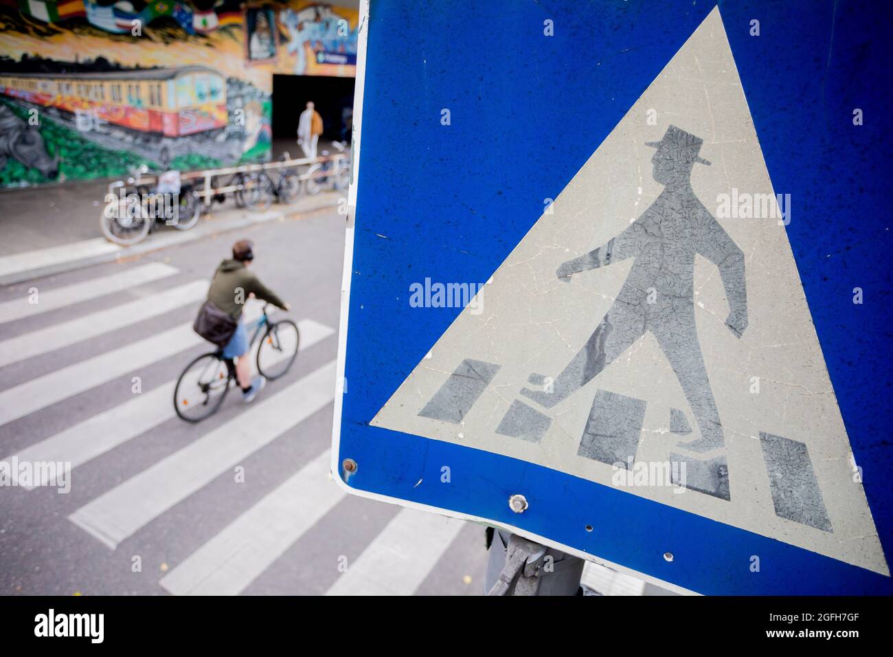 Berlin, Germany. 25th Aug, 2021. A cyclist crosses a zebra crossing at ...
