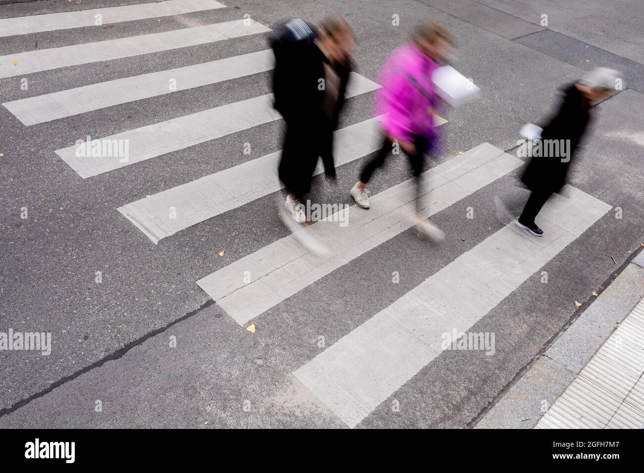 Berlin, Germany. 25th Aug, 2021. Pedestrians crossing a zebra crossing ...