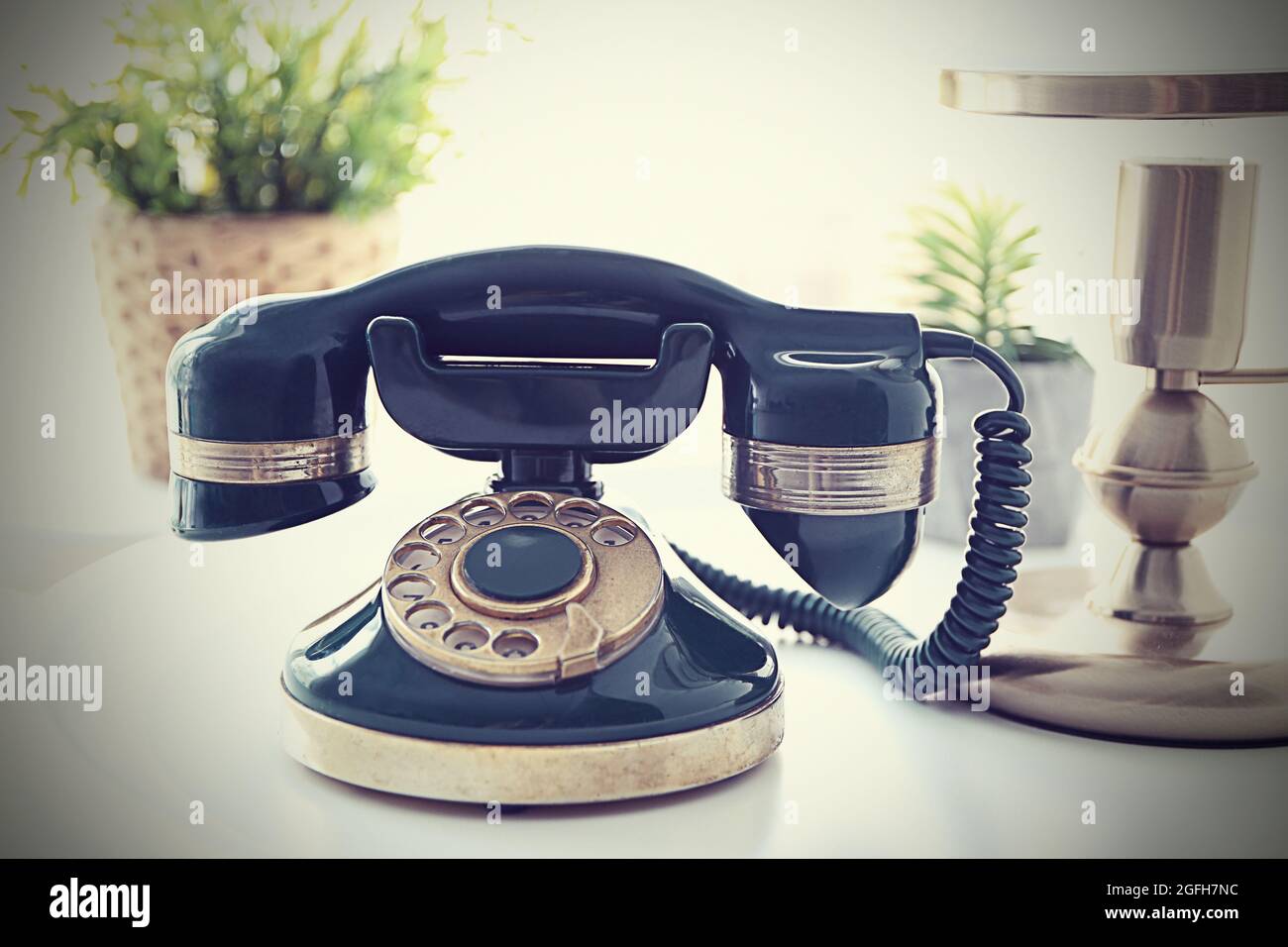 Vintage telephone on white table Stock Photo - Alamy