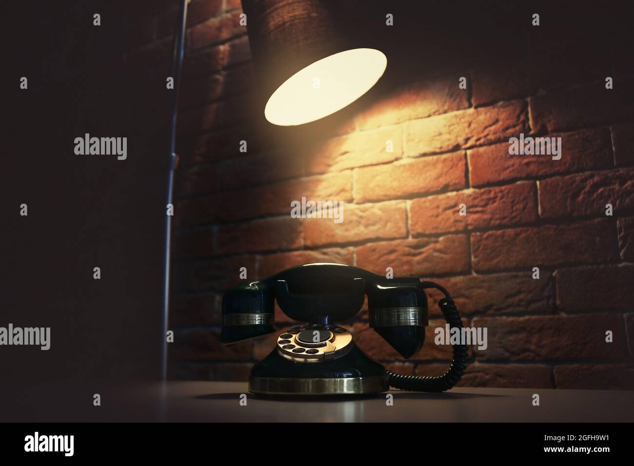 Old telephone on the table in dark room Stock Photo - Alamy