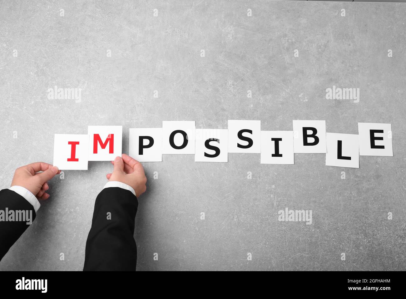 Human hands turning word impossible into possible Stock Photo - Alamy