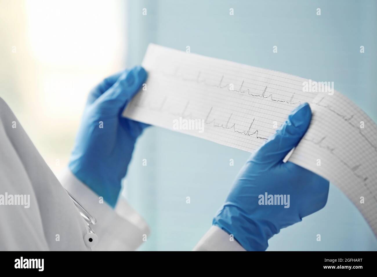 Cardiologist holding cardiogram in hospital Stock Photo - Alamy