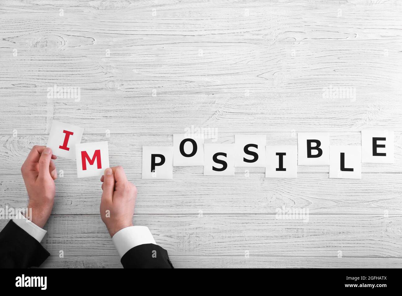 Human hands turning word impossible into possible Stock Photo - Alamy