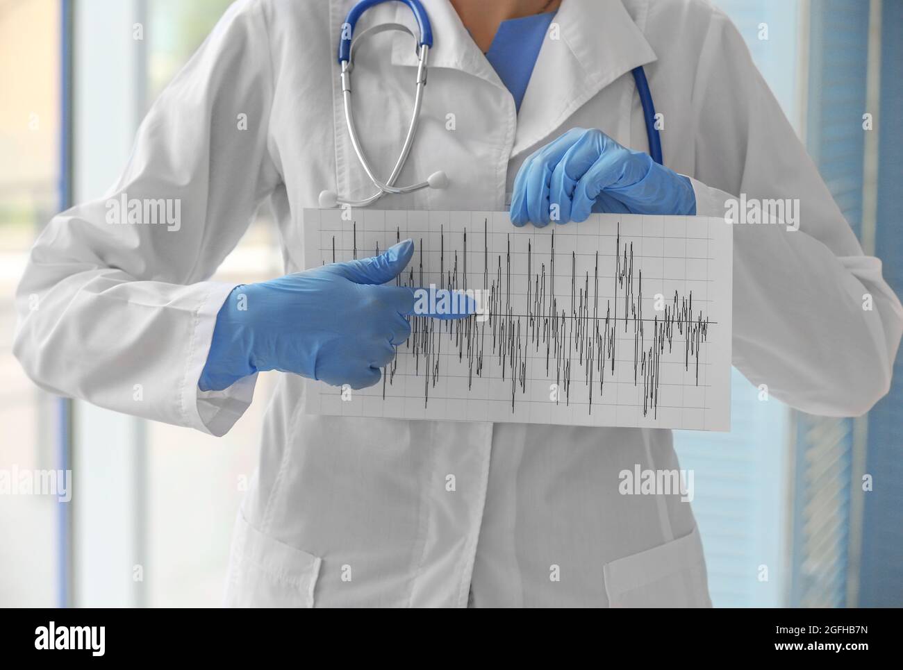 Cardiologist with stethoscope holding cardiogram in hospital Stock ...