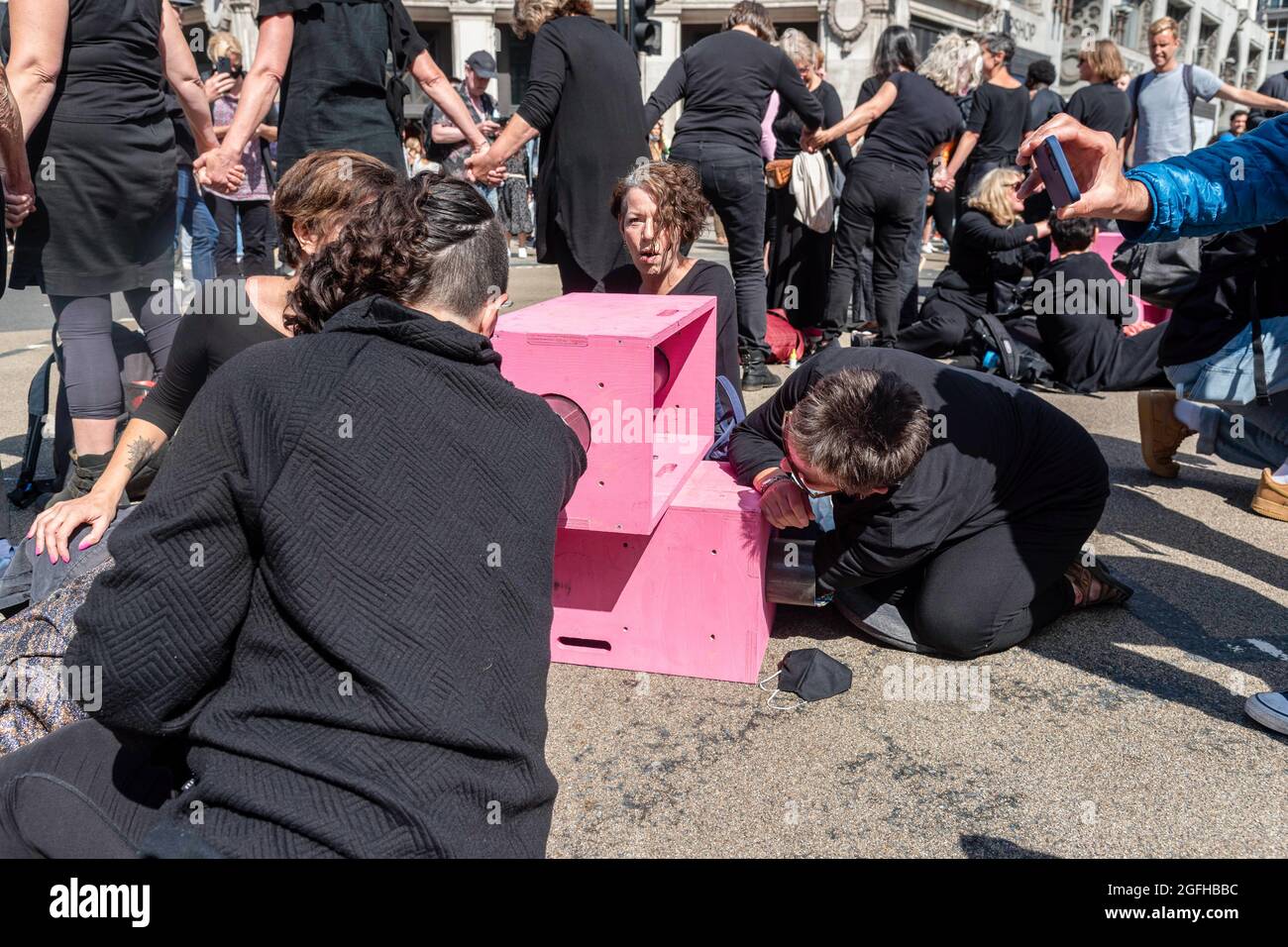 London, UK. 25th Aug, 2021. Protesters lock themselves together during ...