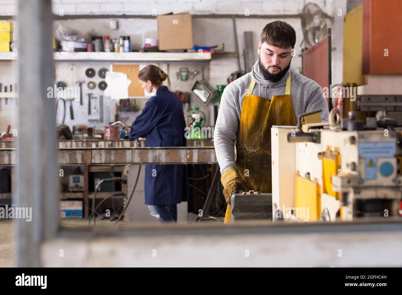 Craftsman working on milling machine Stock Photo - Alamy