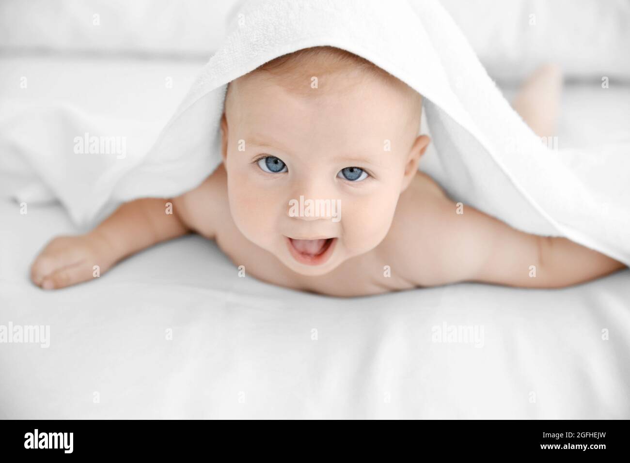Cute little baby on white bed Stock Photo - Alamy
