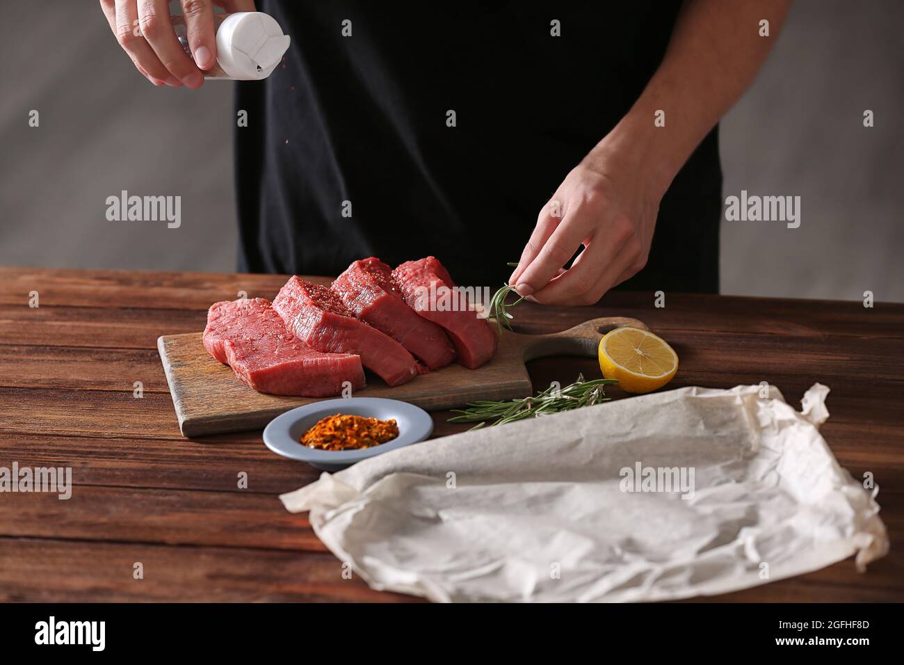 Butcher cooking pork meat on kitchen Stock Photo - Alamy