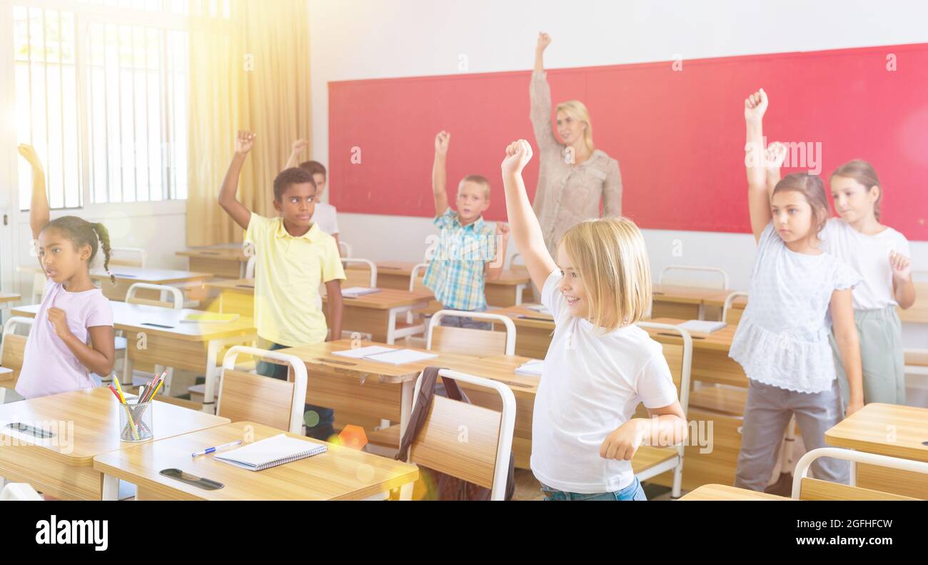 Tweens with female teacher during physical activity break Stock Photo ...