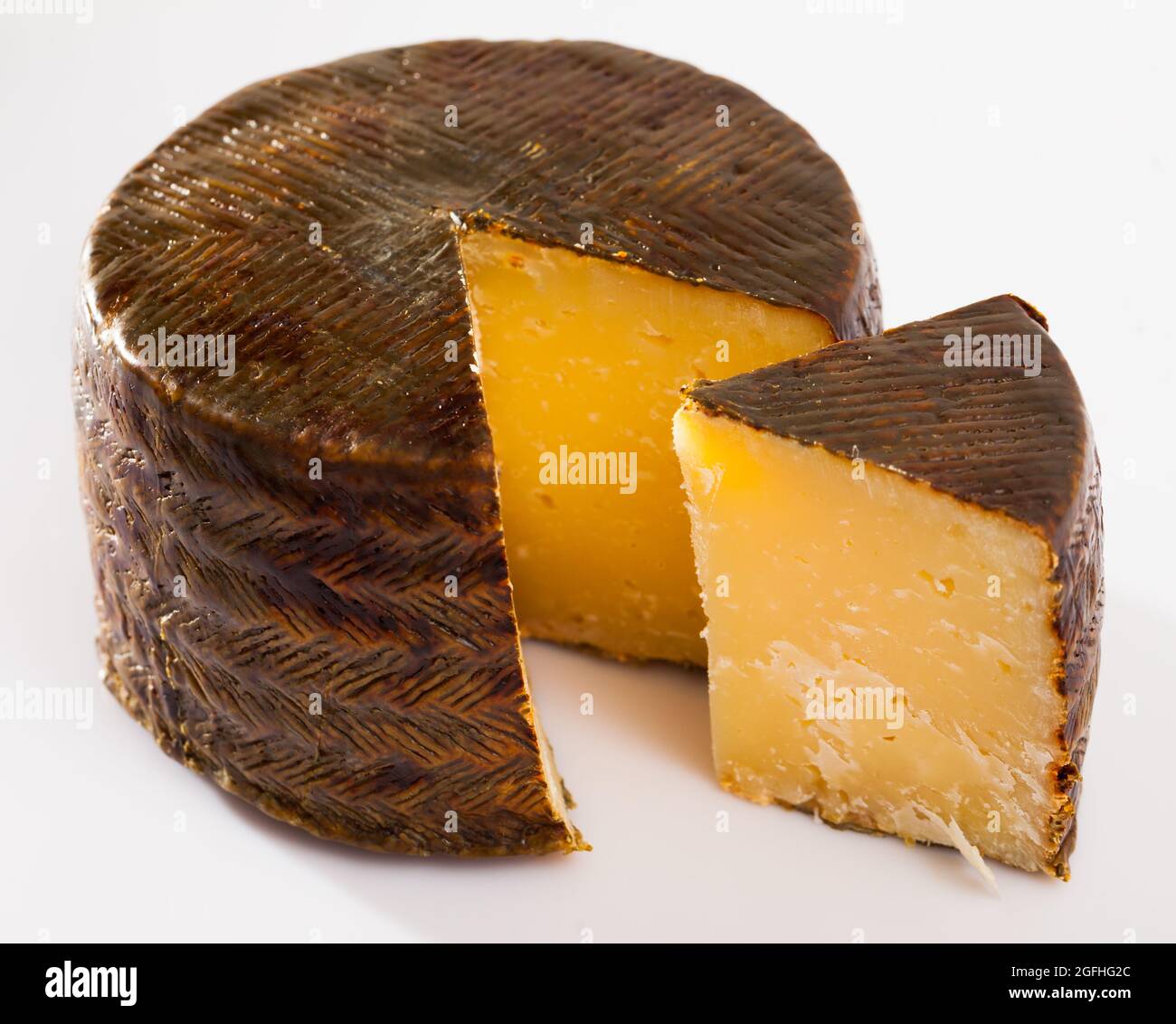 Spanish manchego cheese on a white surface Stock Photo - Alamy