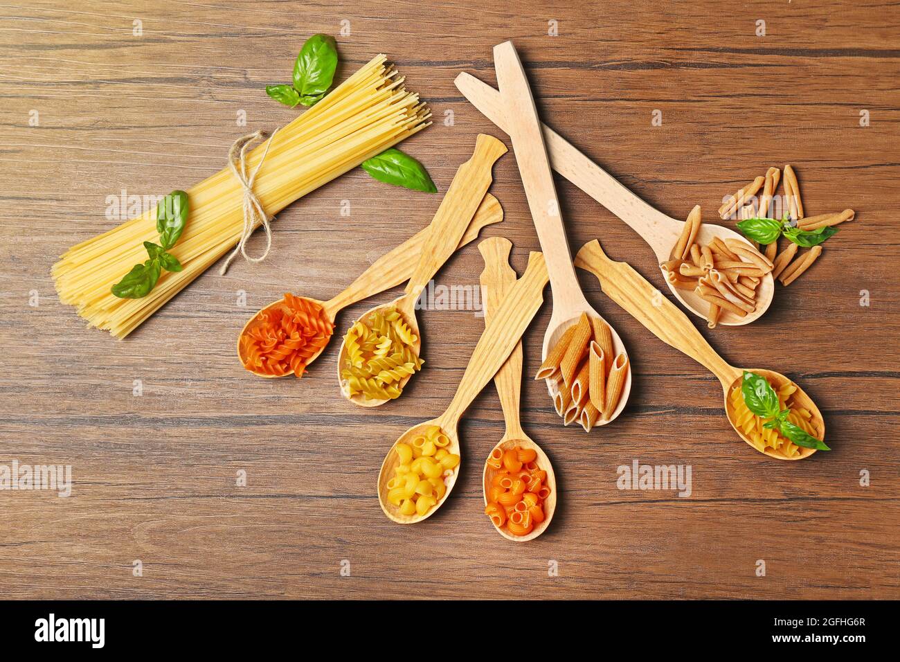 Different dry pasta on measuring spoons Stock Photo - Alamy