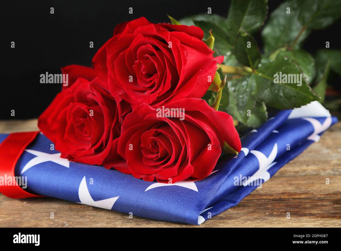 Red roses on American flag, closeup Stock Photo - Alamy
