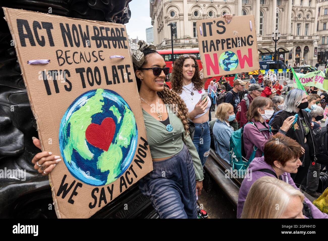 London, UK. 25th Aug, 2021. Protesters hold placards expressing their ...