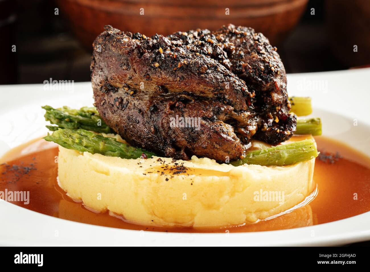 Pepper steak with mashed potatoes and asparagus Stock Photo - Alamy