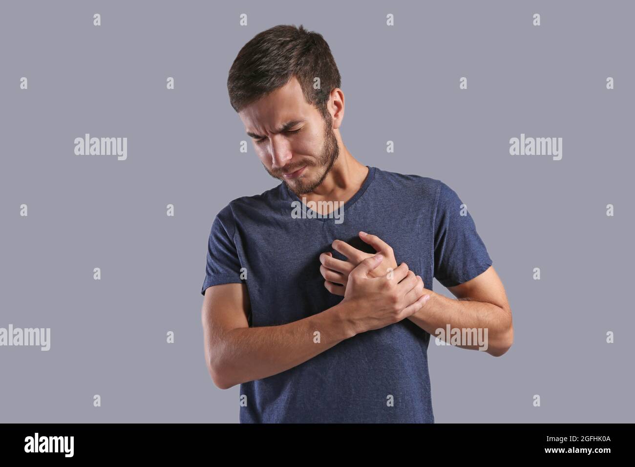 Adult man with heart attack on grey background Stock Photo - Alamy