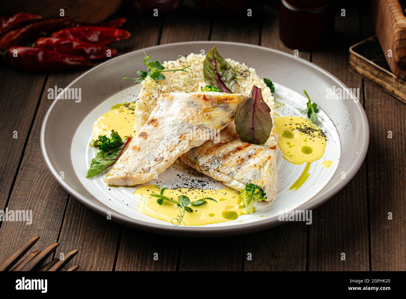 Pike perch fillet on couscous and bearnaise sauce Stock Photo - Alamy
