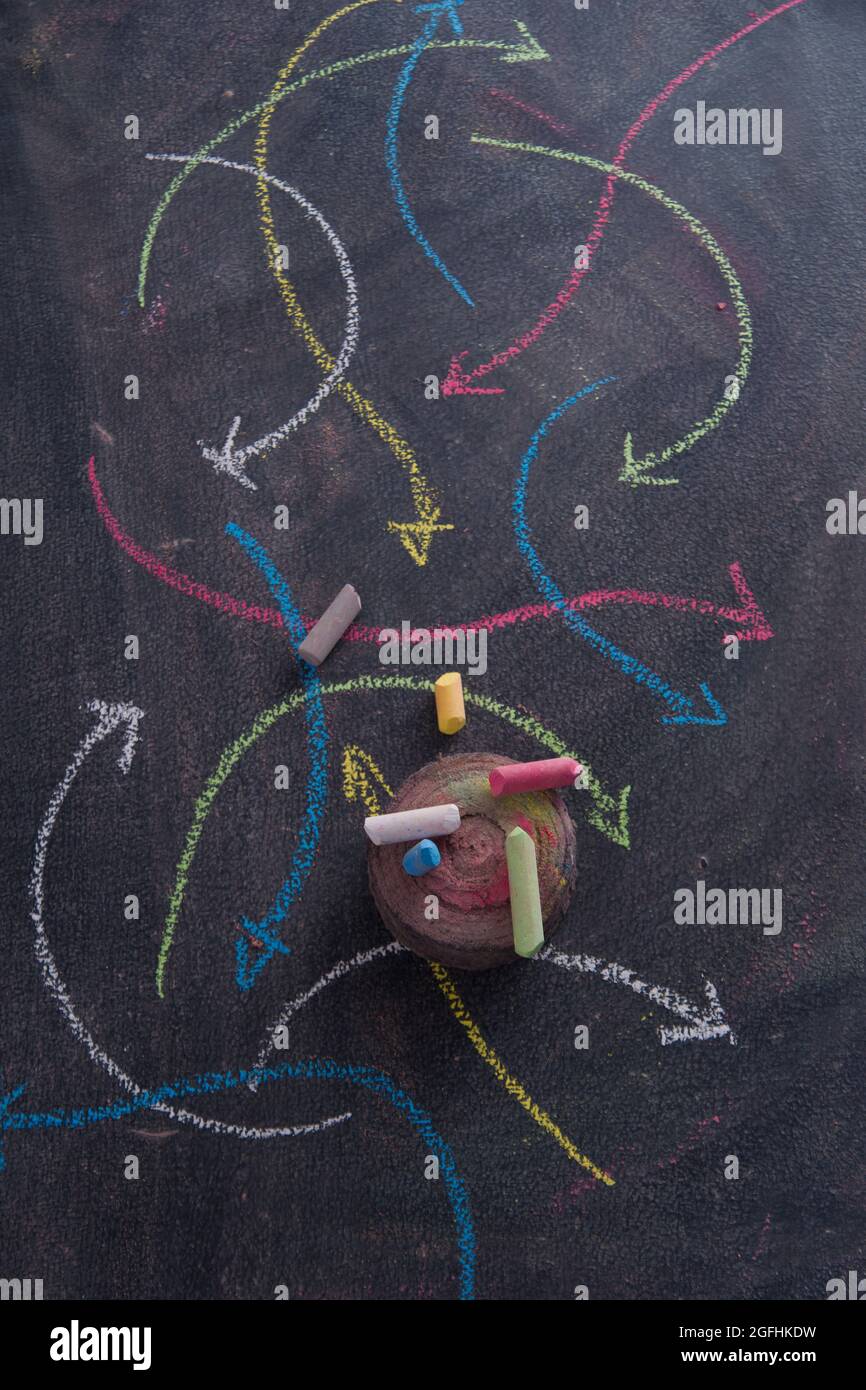 Curved colored arrows drawn with chalk on blackboard Stock Photo - Alamy