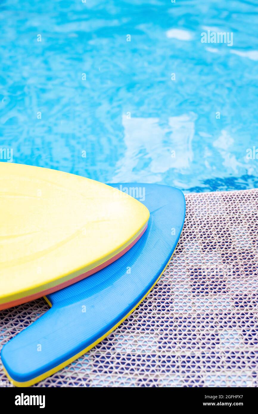 angle view yellow and blue floating pad near a swimming pool vertical ...