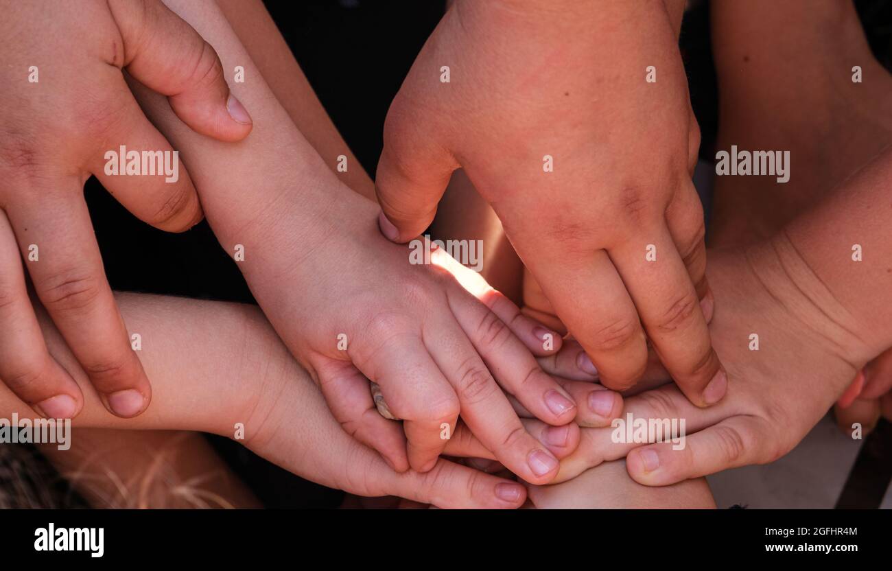 Children's hands piled on top of each other Stock Photo - Alamy