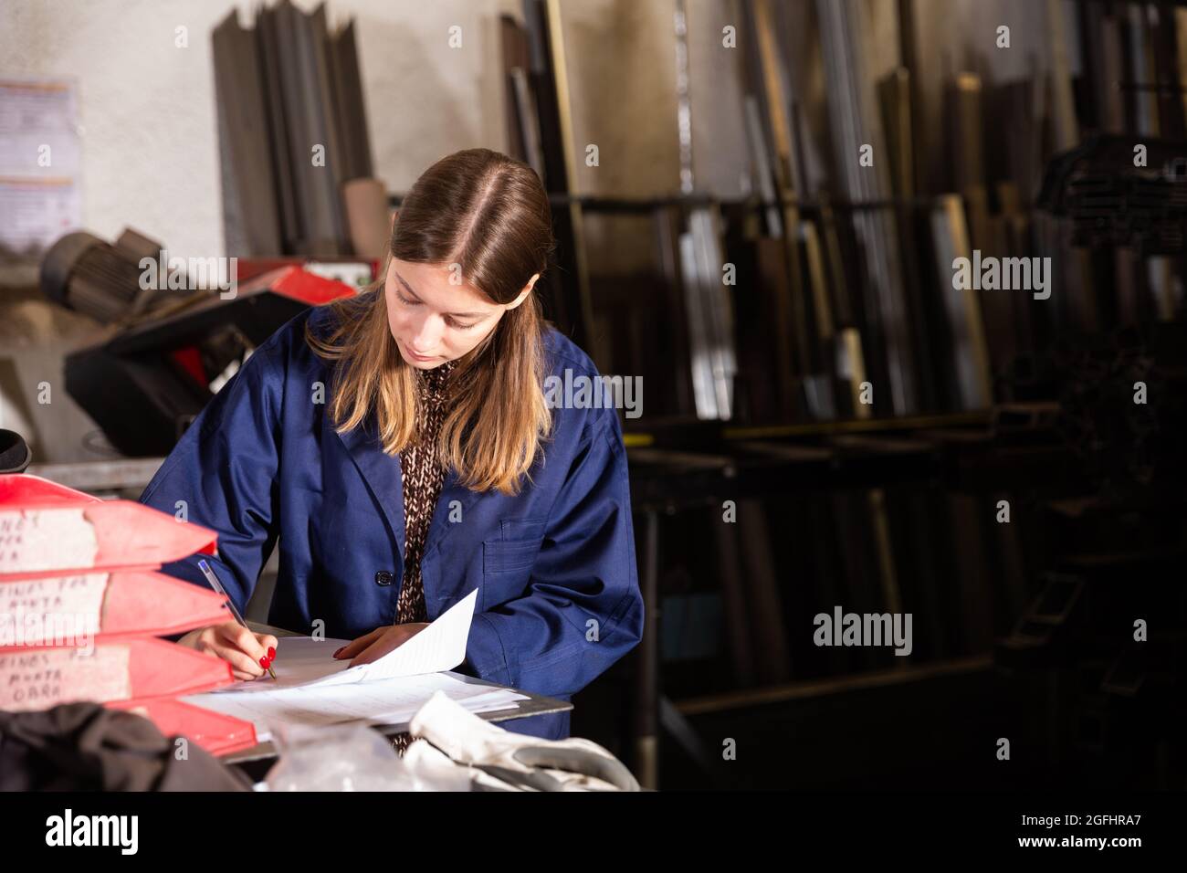 Young woman engineer taking notes in notebook Stock Photo - Alamy