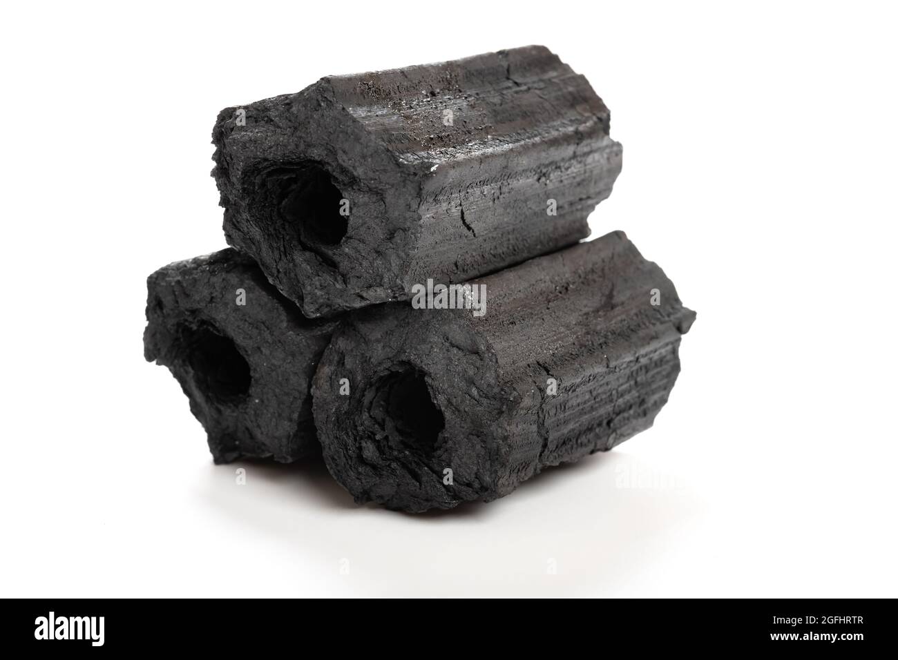 three pieces of charcoal on a white background Stock Photo - Alamy