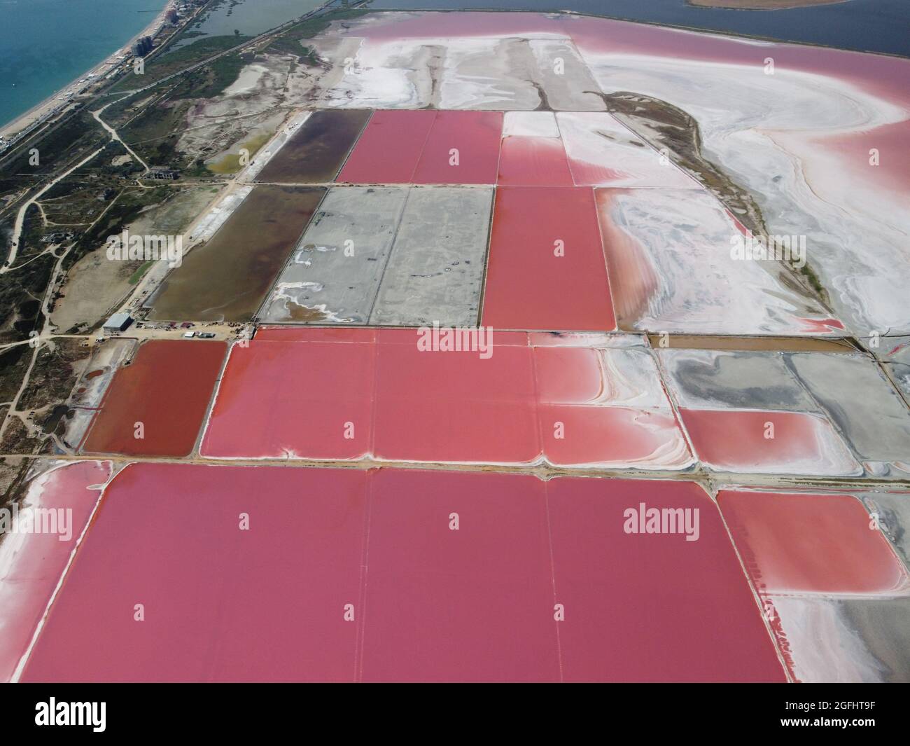 Flying over a pink salt lake. Salt production facilities saline ...