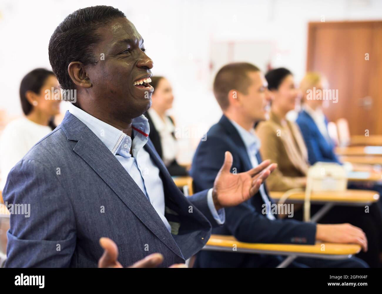 Emotional man listening to speaker at conference Stock Photo - Alamy