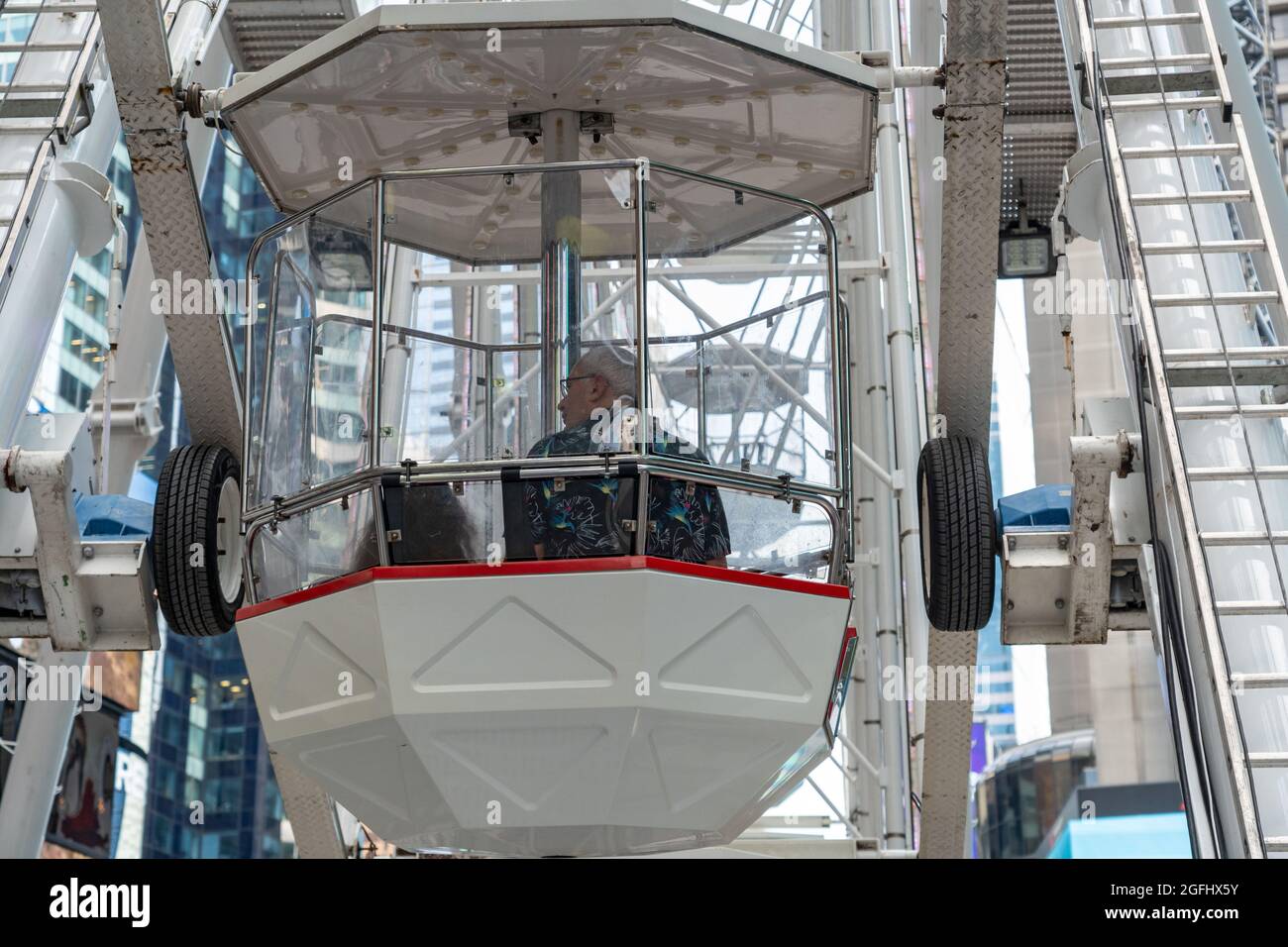 New York, United States. 25th Aug, 2021. People ride the Times Square ...