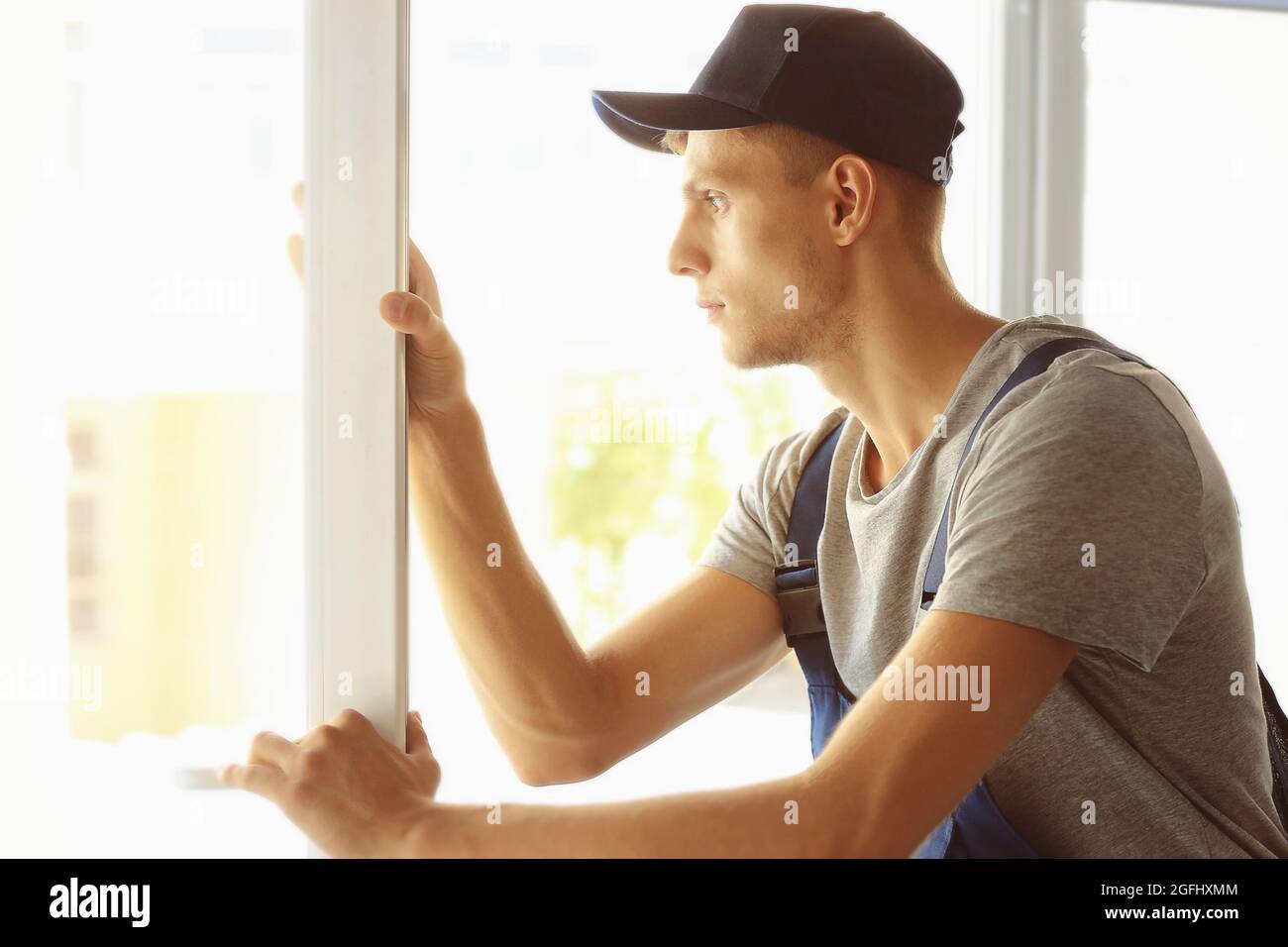 Construction worker installing window in house Stock Photo - Alamy