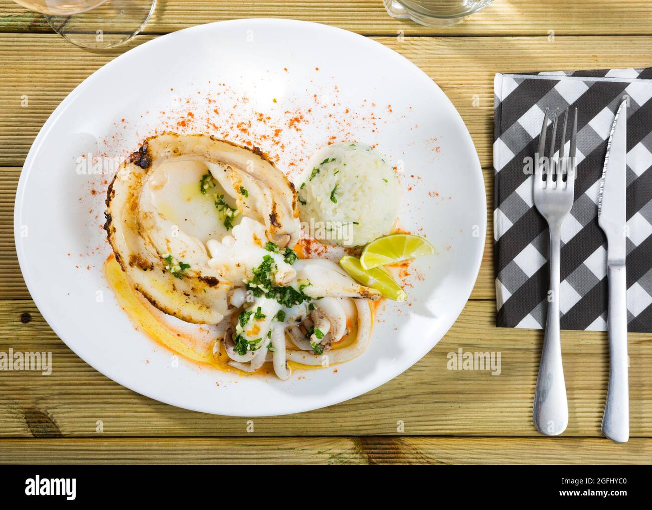 Baked cuttlefish with boiled rice Stock Photo - Alamy