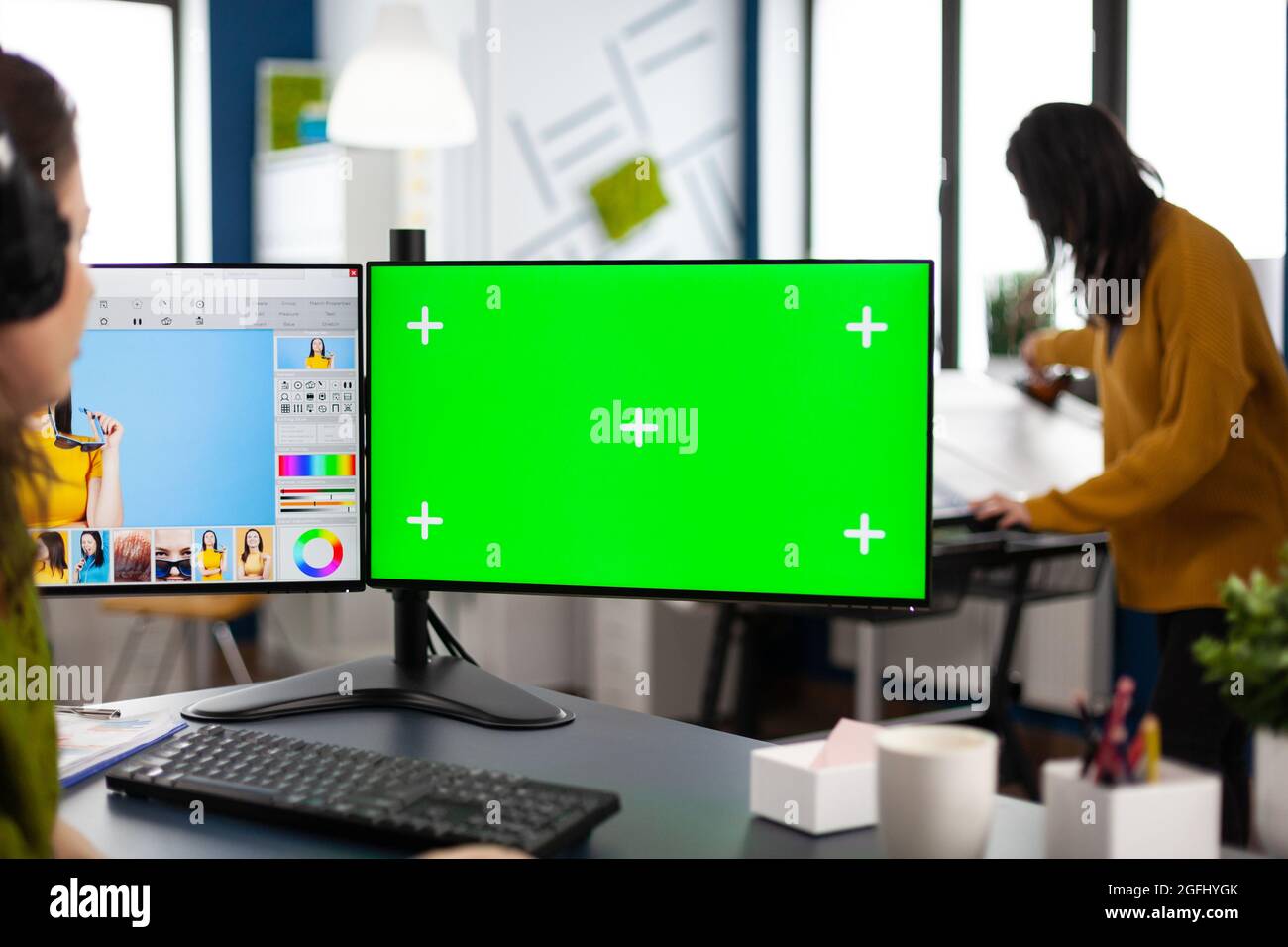 Woman digital artist working editing creative photo using greenscreen ...