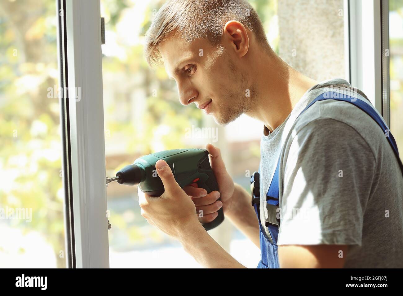 Construction worker installing window in house Stock Photo - Alamy
