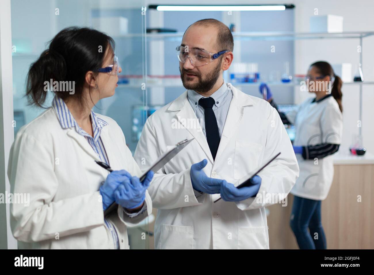 Hospital researcher team discussing virus prevention during ...