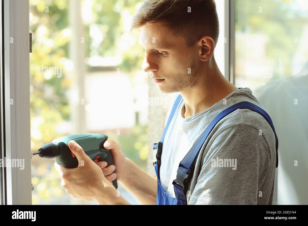 Construction worker installing window in house Stock Photo - Alamy