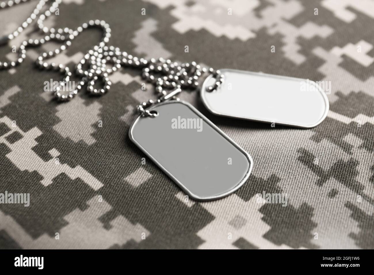 Army tokens on military uniform background Stock Photo - Alamy