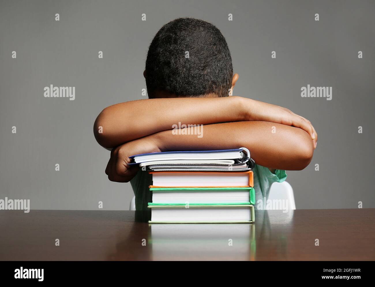 African American boy sleeping on books on grey background Stock Photo ...