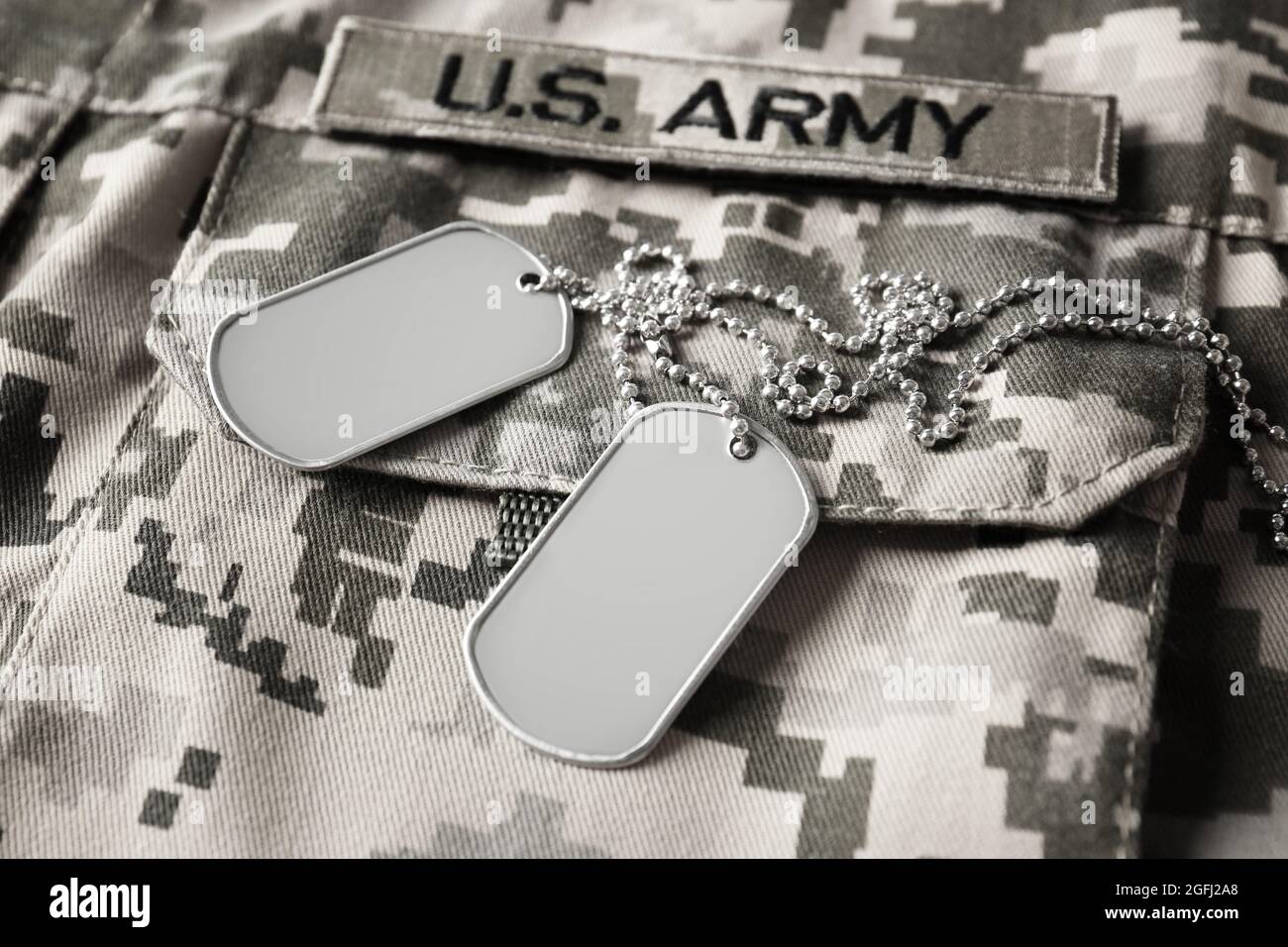 Army tokens and patch on military uniform background Stock Photo - Alamy