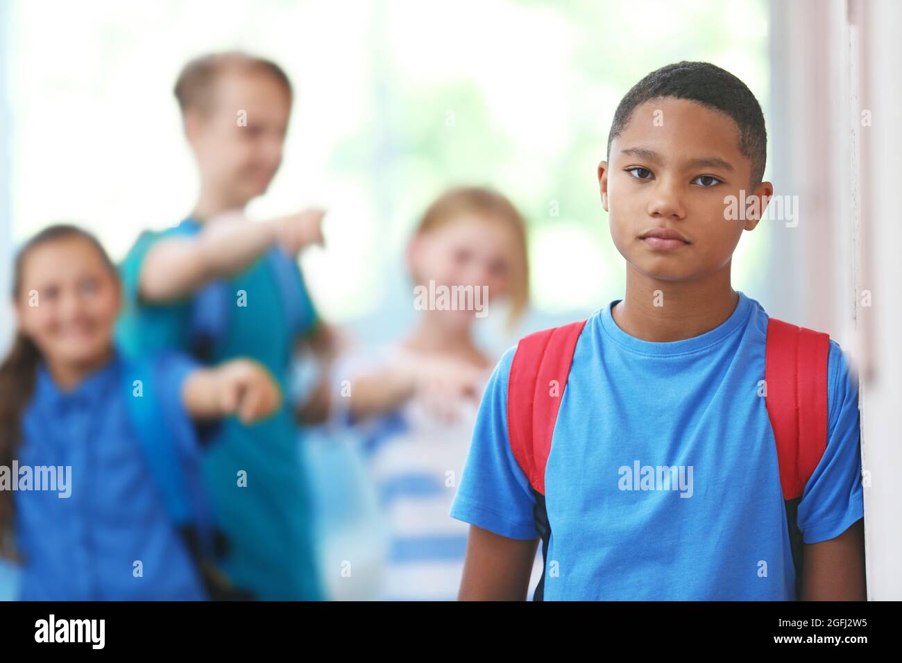 Sad African American boy in school Stock Photo - Alamy